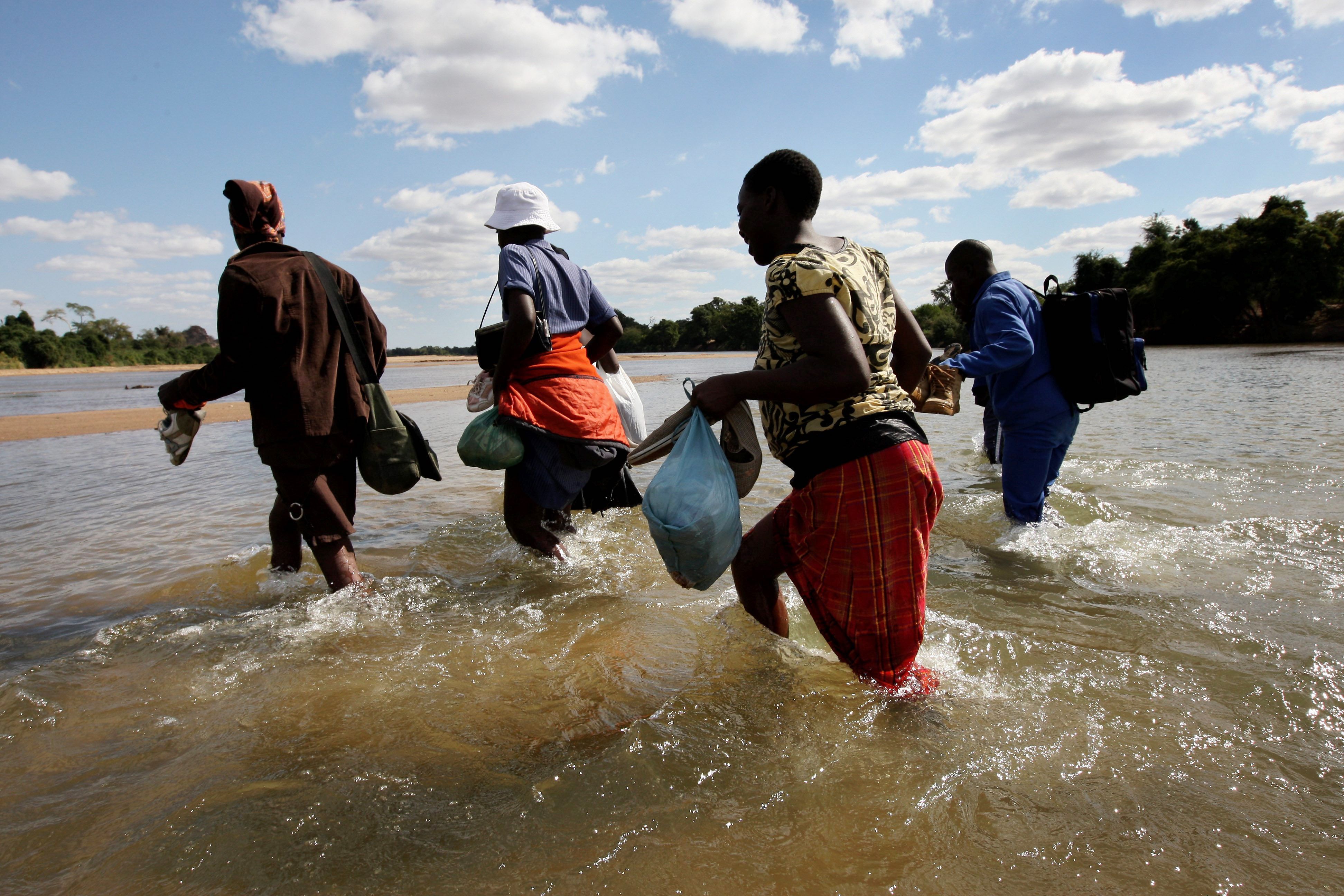 Mexicans Crossing The Border Illegally In Water